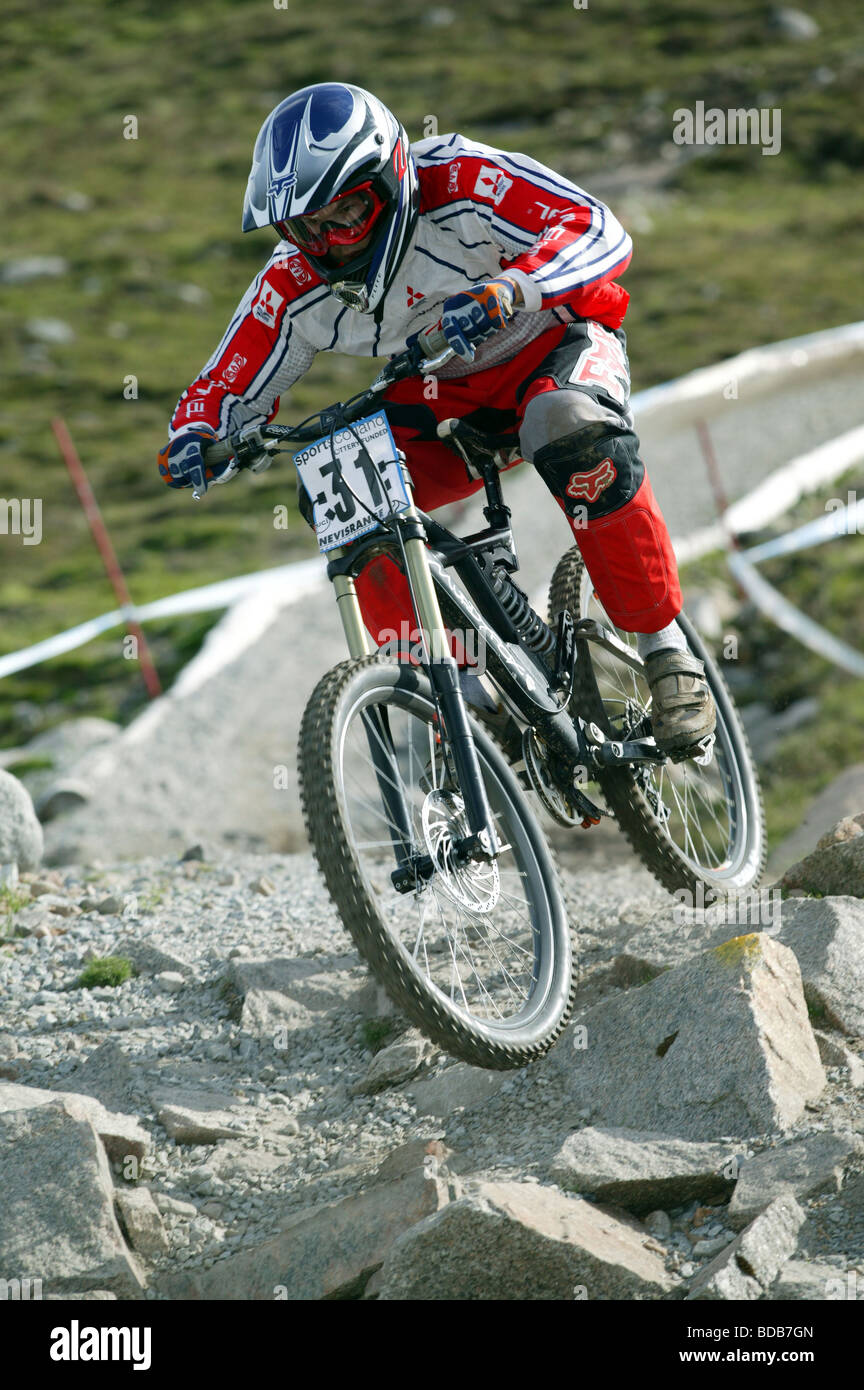 A Downhill Mountain Biker racing down a mountain course Stock Photo - Alamy