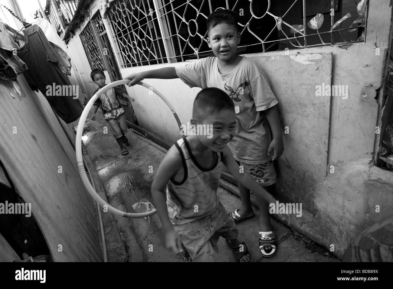 kids playing with hoop at Klongtoei community,Bangkok,Thailand Stock ...