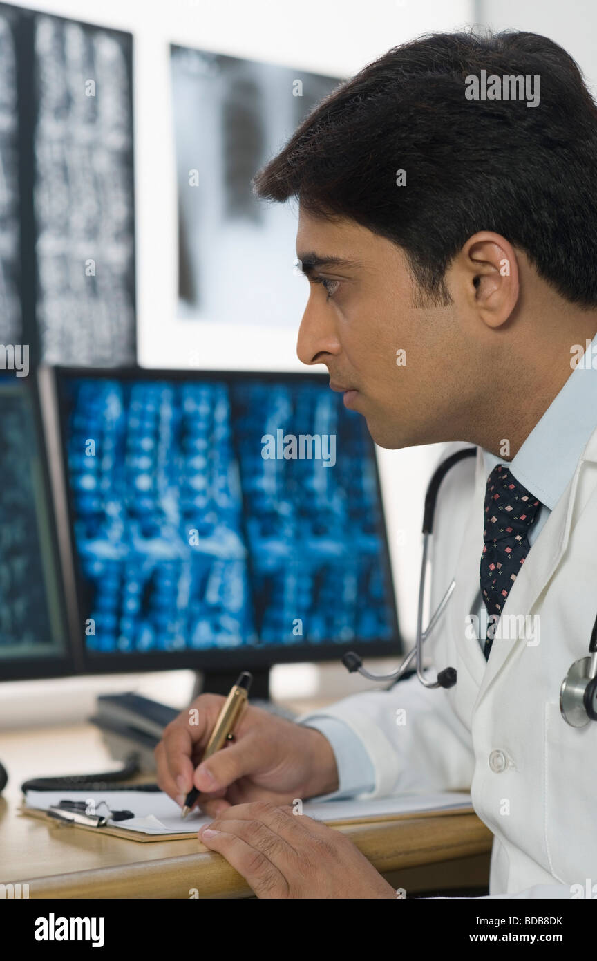 Male doctor writing a prescription Stock Photo - Alamy