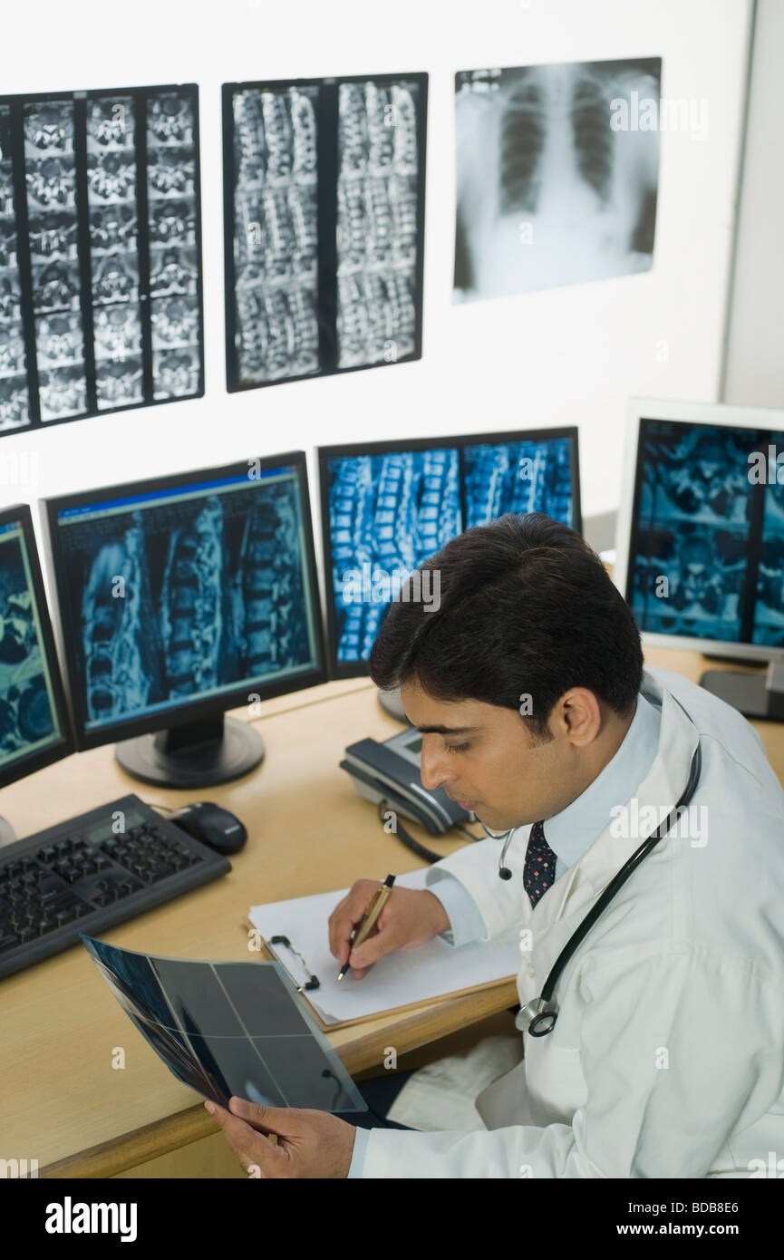 Male doctor writing a prescription Stock Photo - Alamy