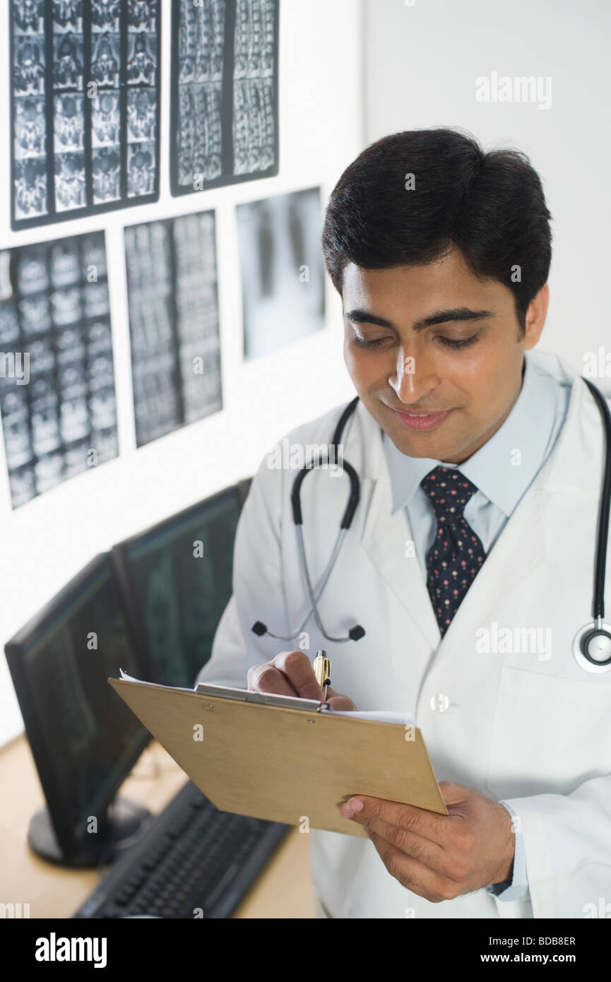 Male doctor writing a prescription Stock Photo - Alamy