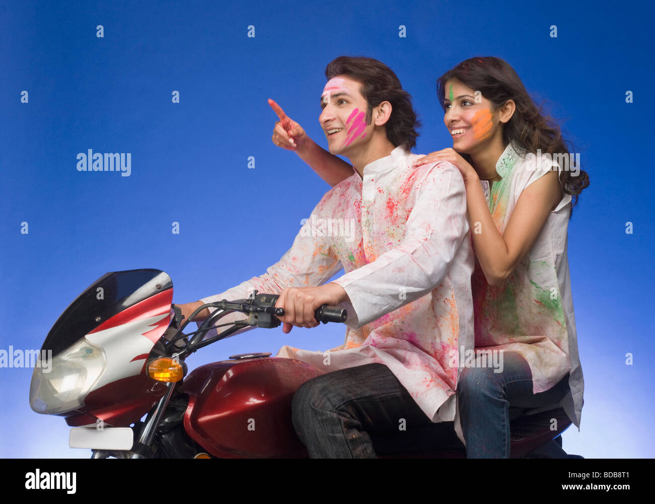 Couple riding a motorcycle Stock Photo - Alamy