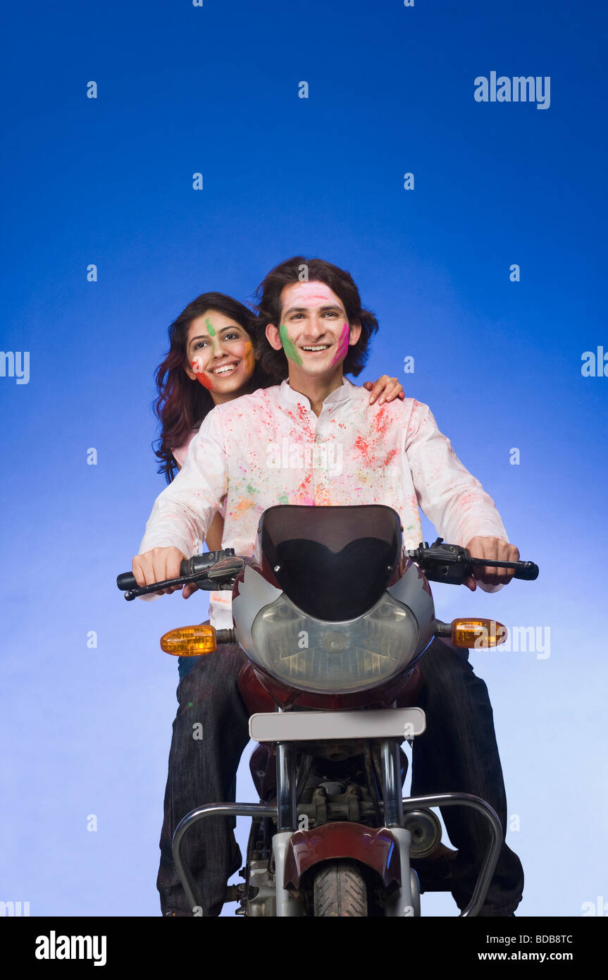 Couple riding a motorcycle Stock Photo - Alamy