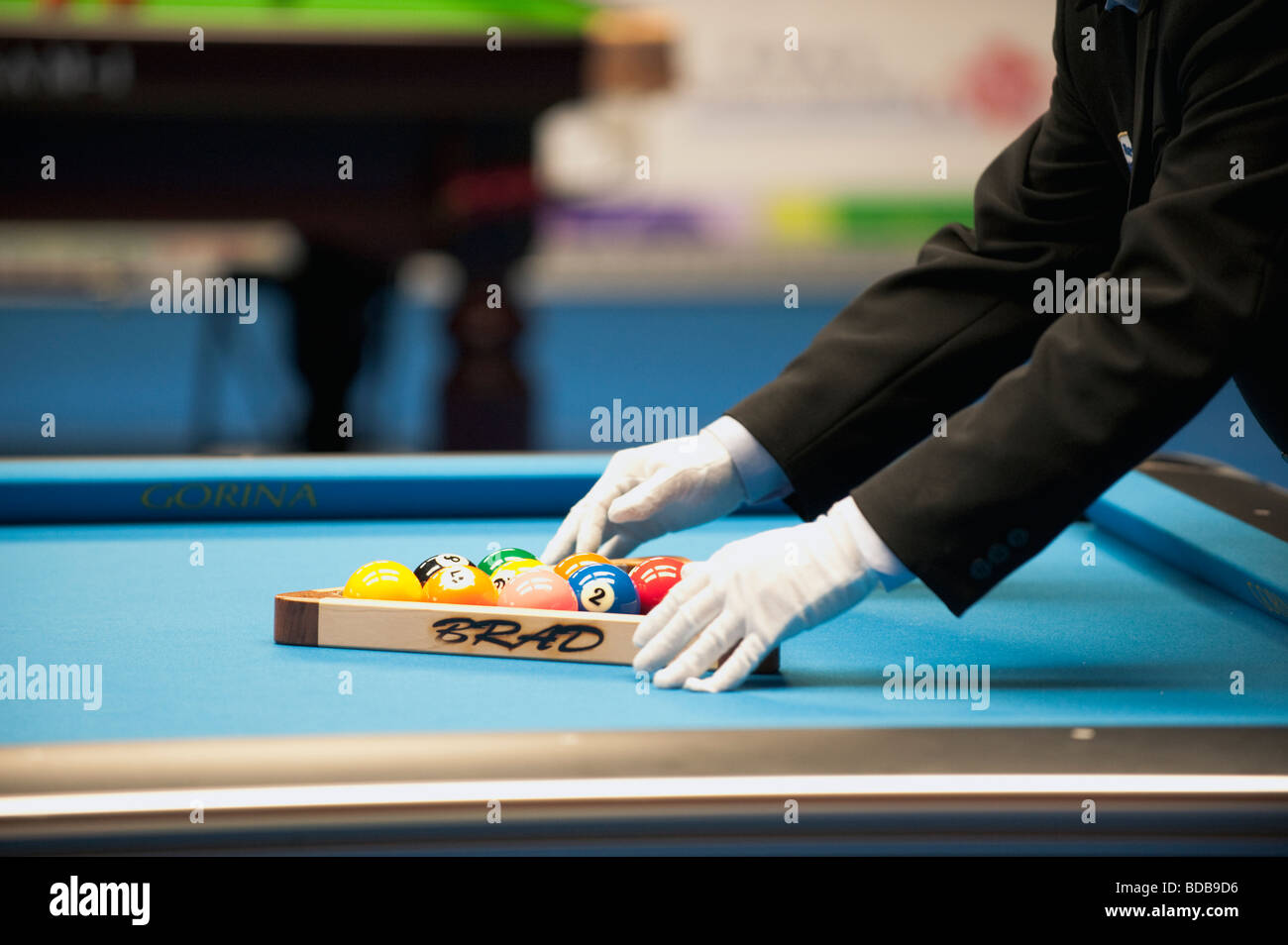 Man racking the balls in billiards 9 ball competition, close up view ...