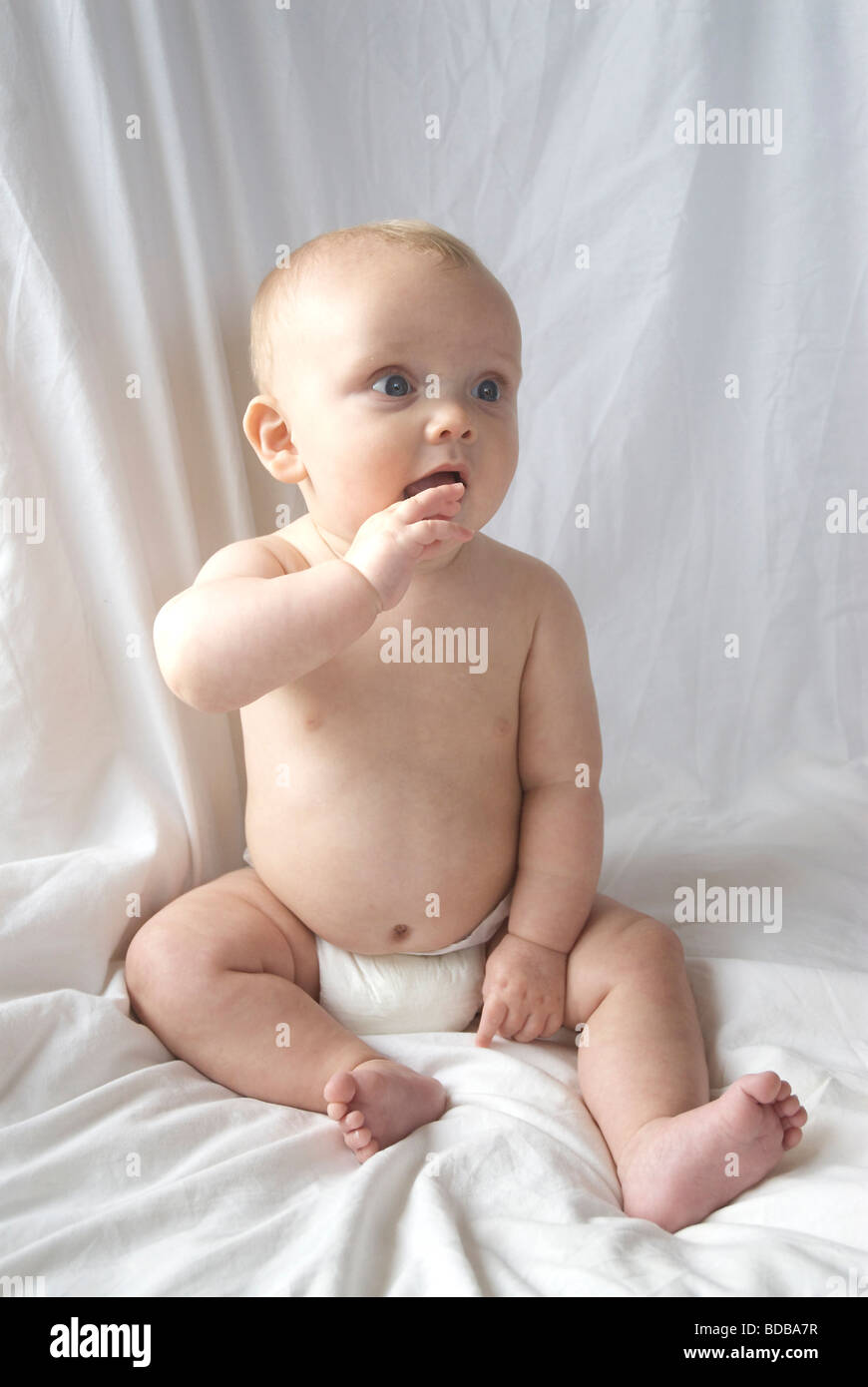 A baby sitting up in his nappy Stock Photo - Alamy