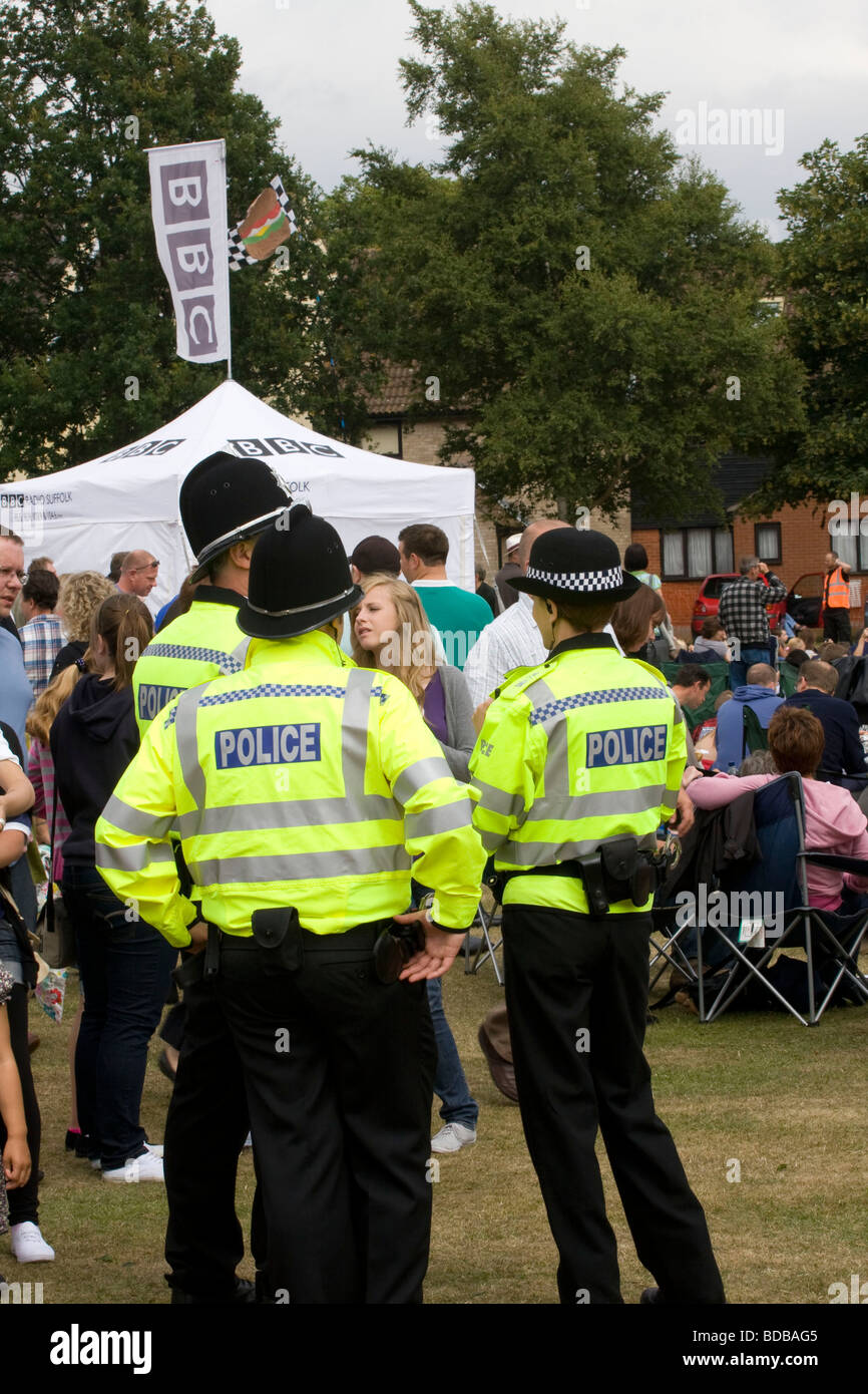 Two policemen and a police woman all in hi-vis yellow jackets at an ...