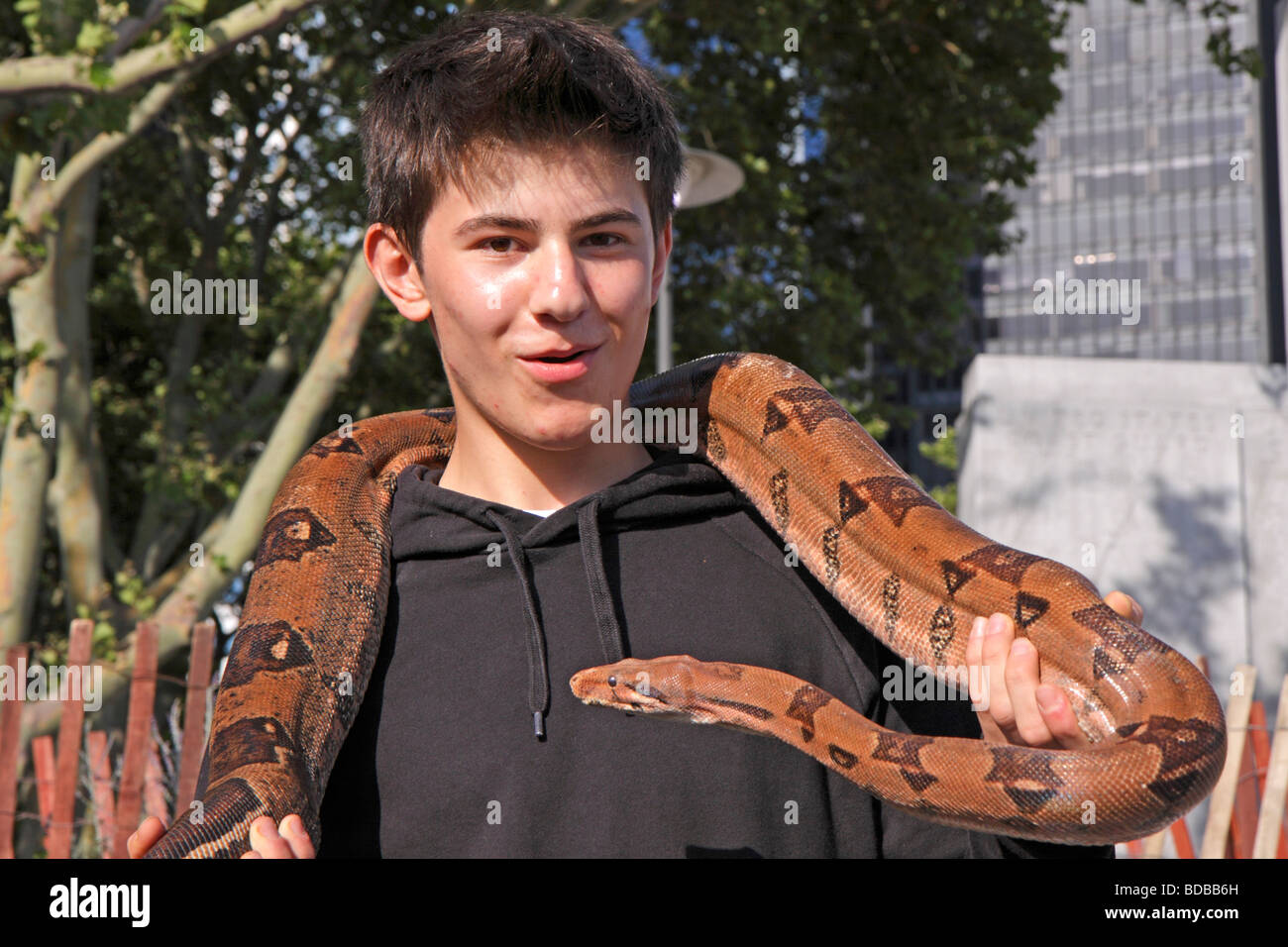 teenage boy with a constrictor snake around his neck, New York City ...