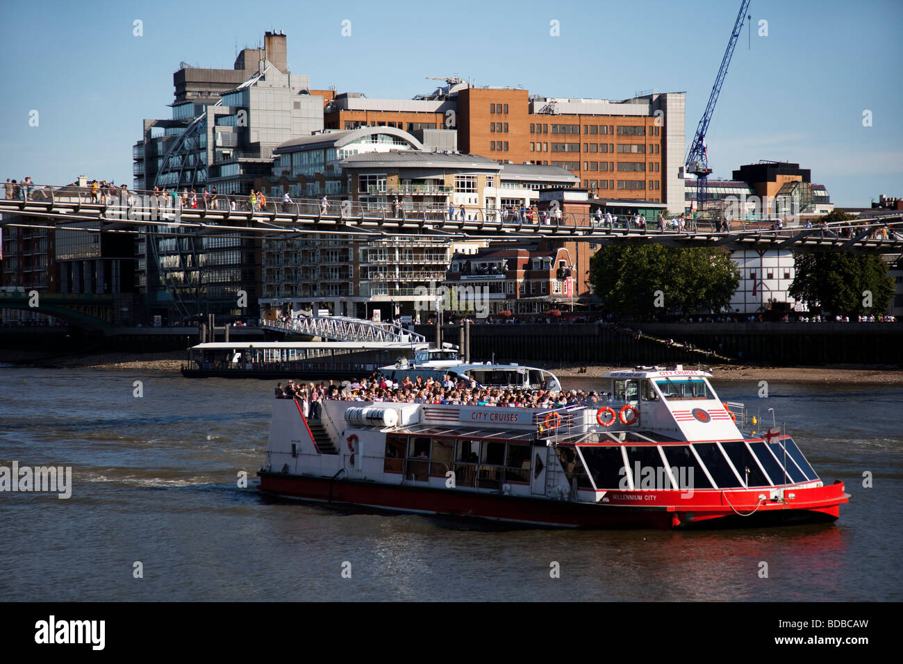 Scene of the River Thames London. Tour boat cruises pass Millennium ...