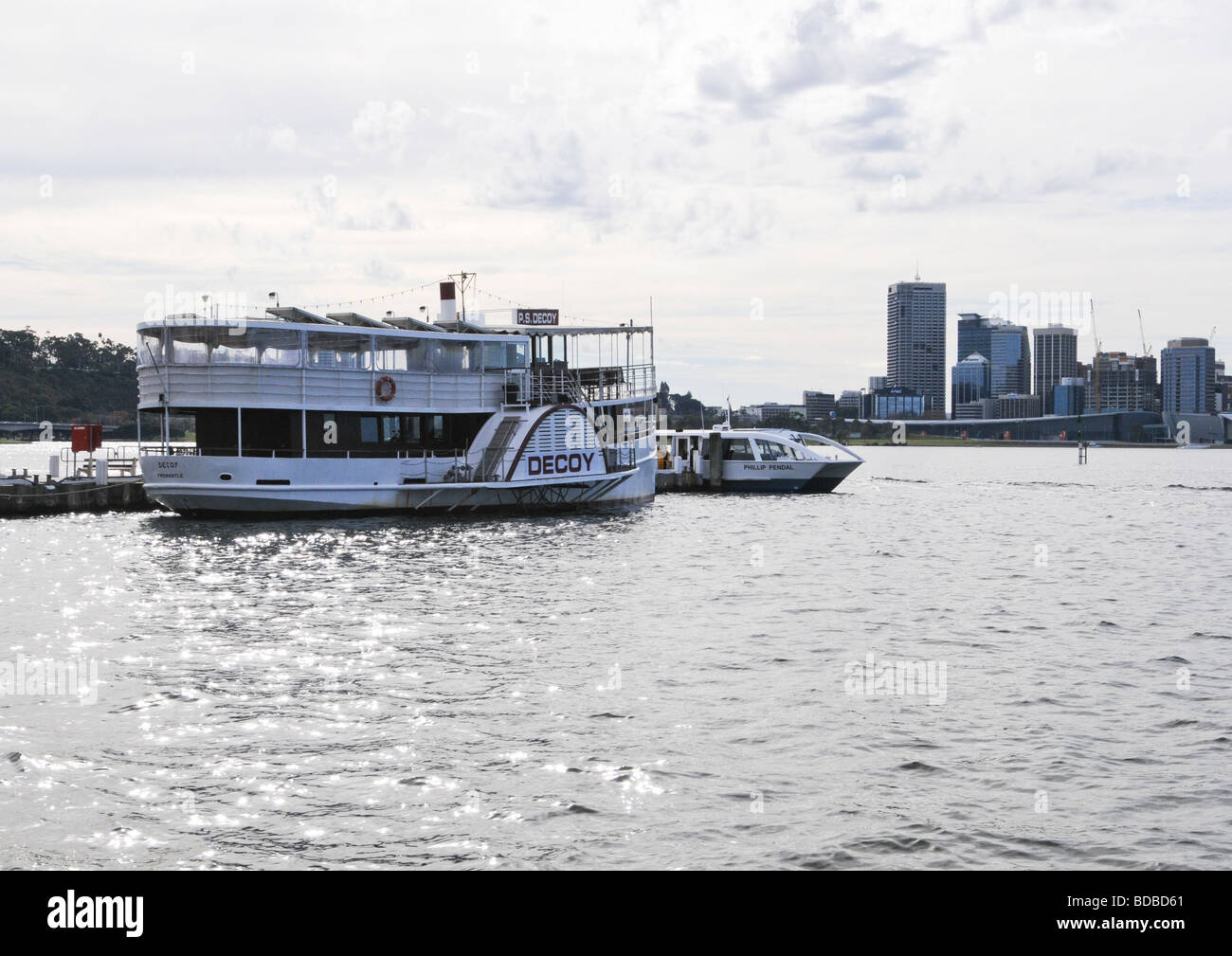 Large old fashioned cruise ship and a boat anchored at jetty on Swan ...