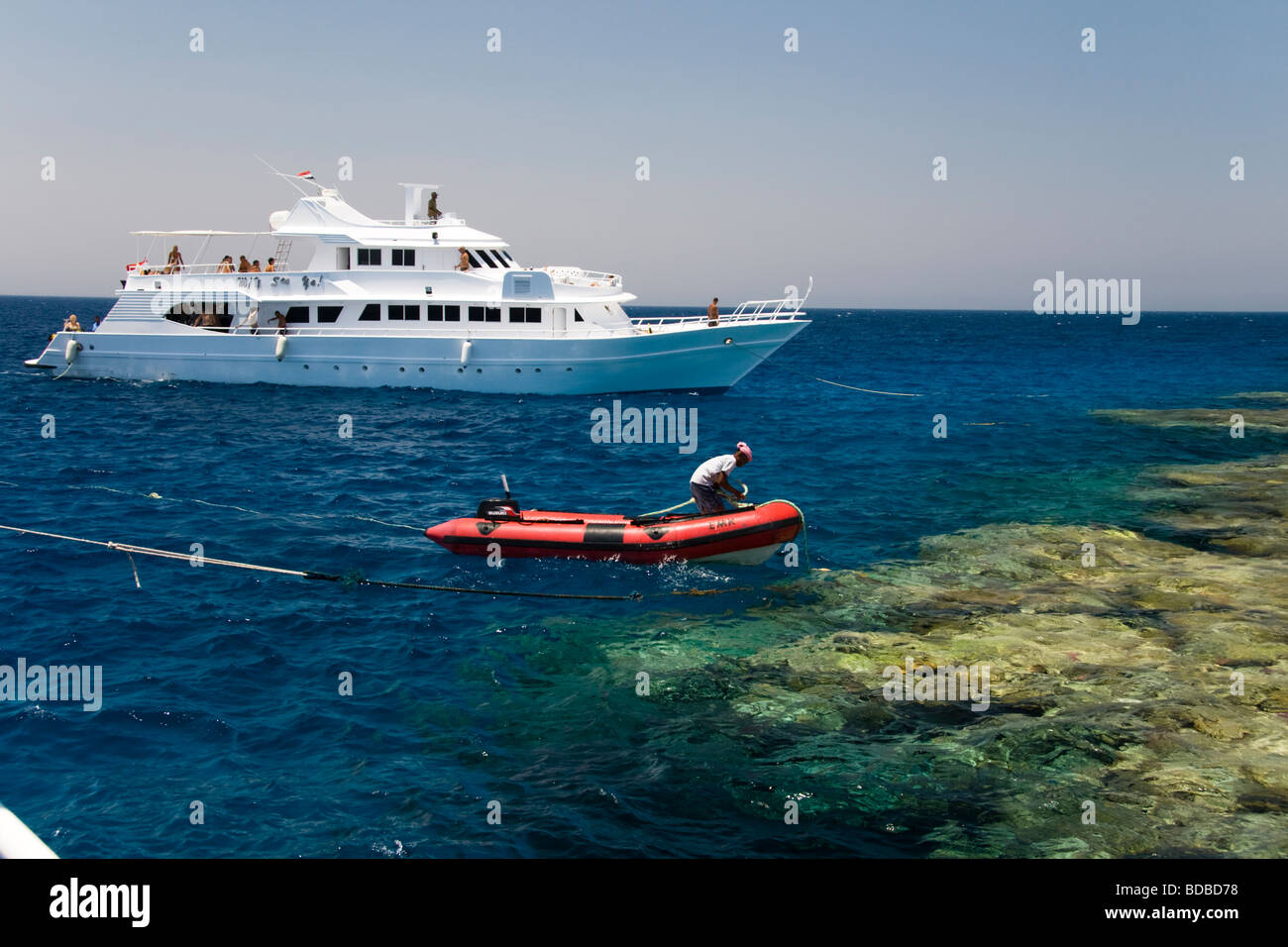 Dive boat and inflatable Zodiac moored on a coral reef Red Sea Egypt ...