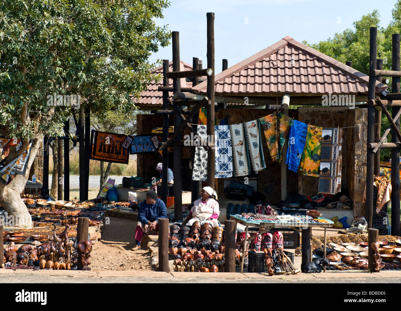An African sales women arranging art and craft items for display in her ...