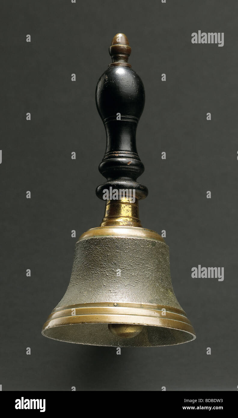 Looking up at a hand bell floating on grey background Stock Photo - Alamy