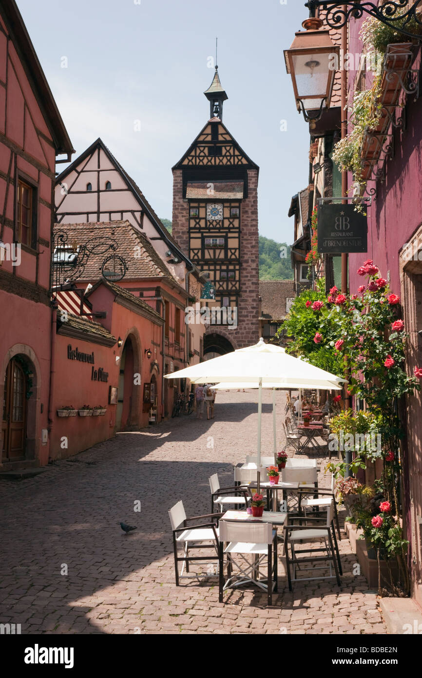 Pavement cafe Dolder Tower gate and old buildings on narrow cobbled ...