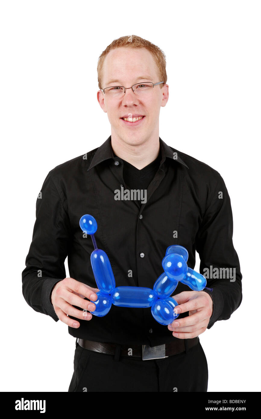 young magic tinkering a balloon animal with balloons Stock Photo - Alamy