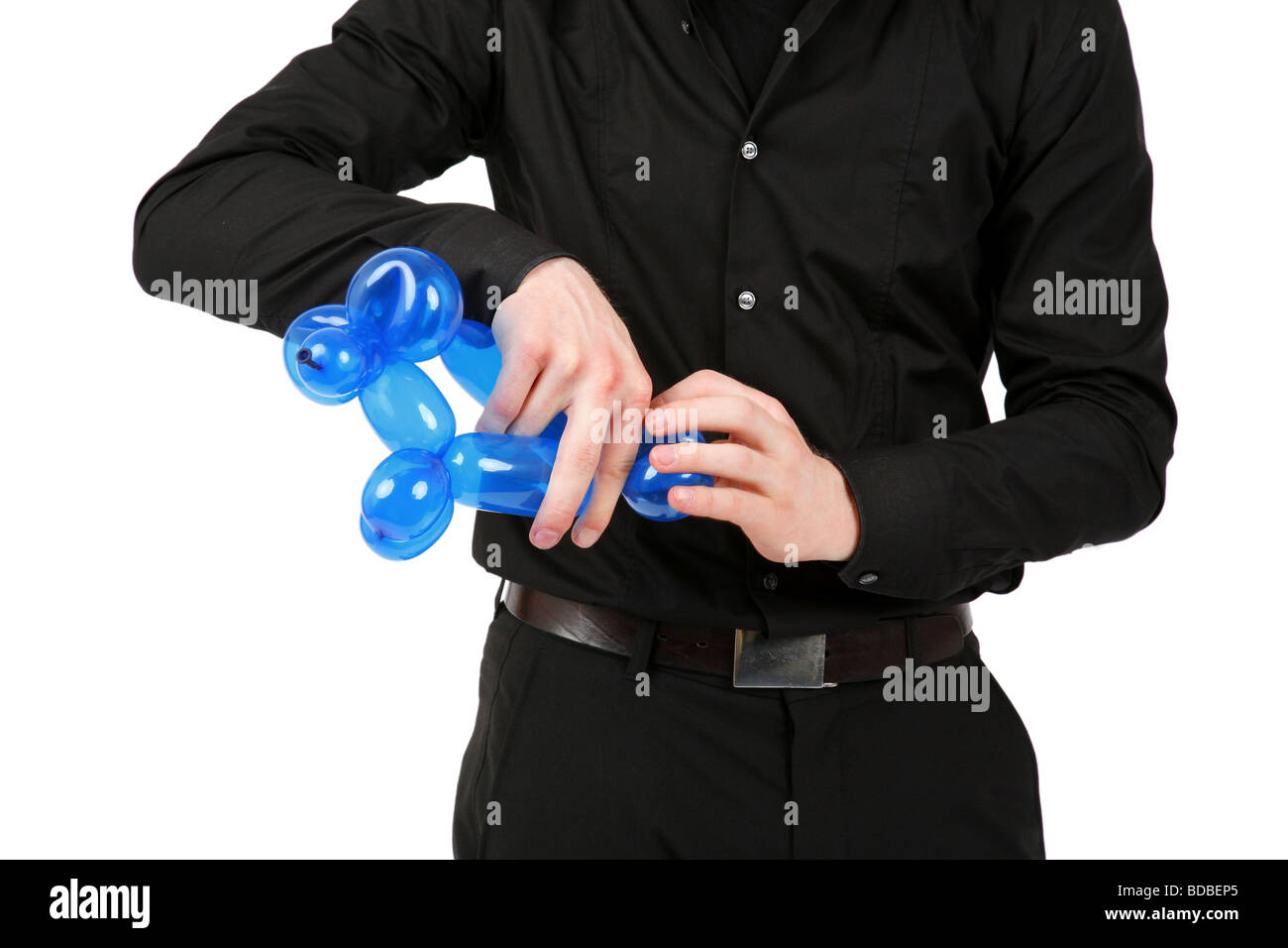 young magic tinkering a balloon animal with balloons Stock Photo - Alamy