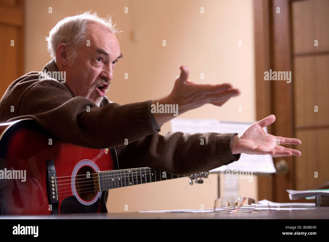 mature music instructor making gesture during lesson Stock Photo - Alamy