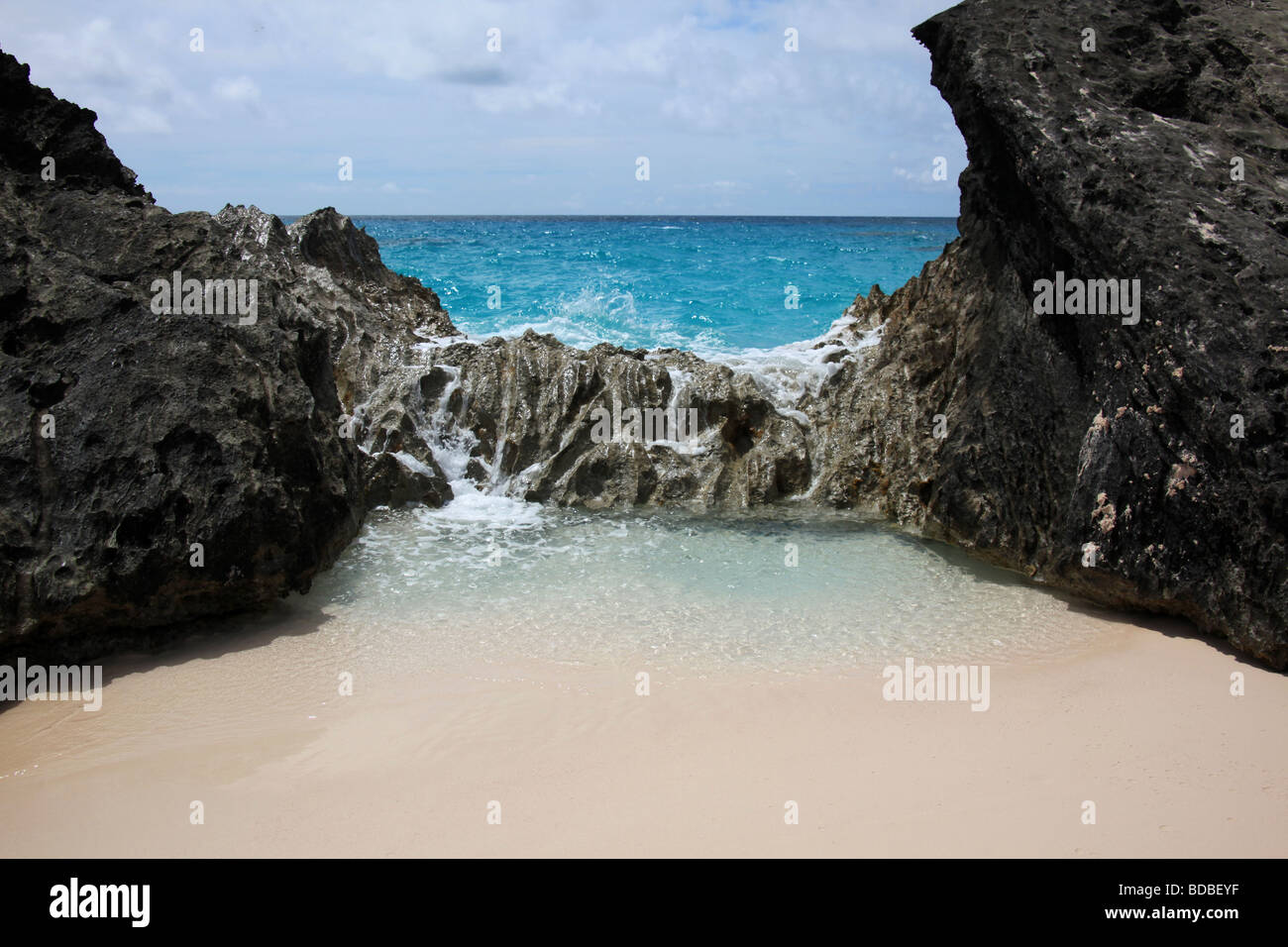 The beautiful aqua waters of Bermuda seen here in a wave splashing on a ...