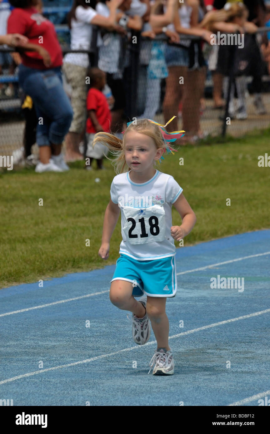 Young female runner at the Track and Field competition during the ...