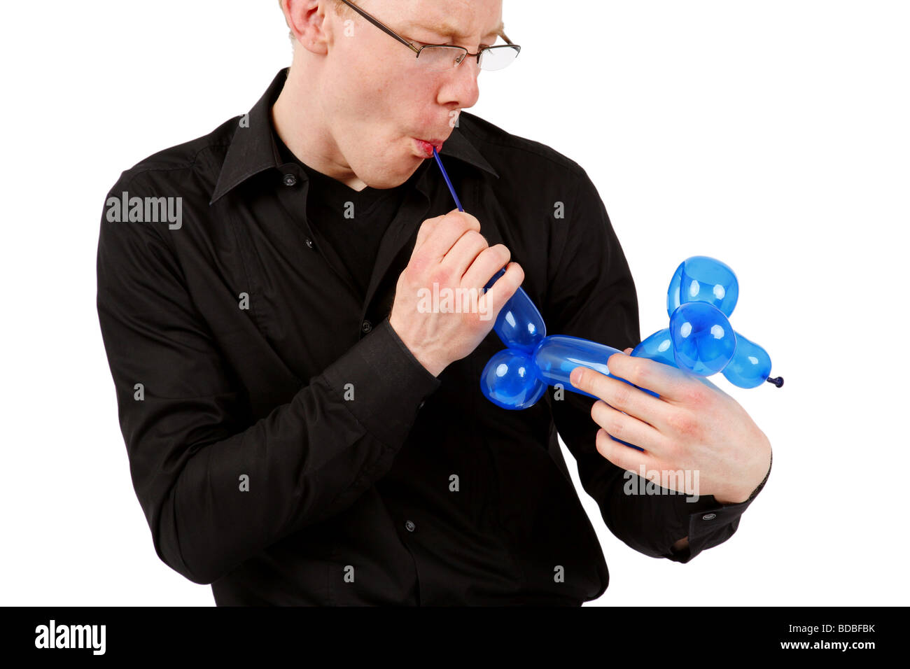 young magic tinkering a balloon animal with balloons Stock Photo - Alamy