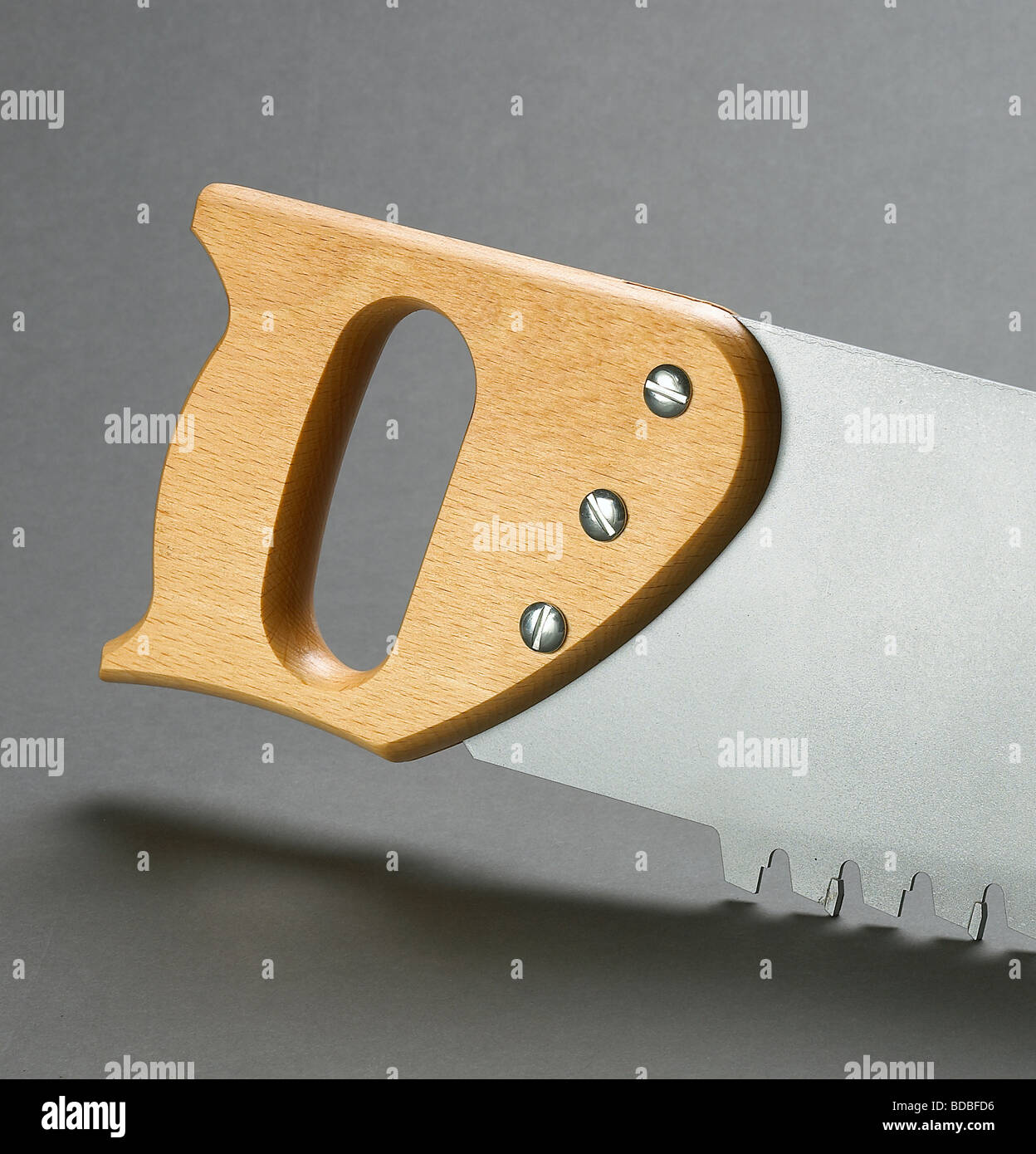Wooden handle of saw standing on the blade on a grey background Stock ...
