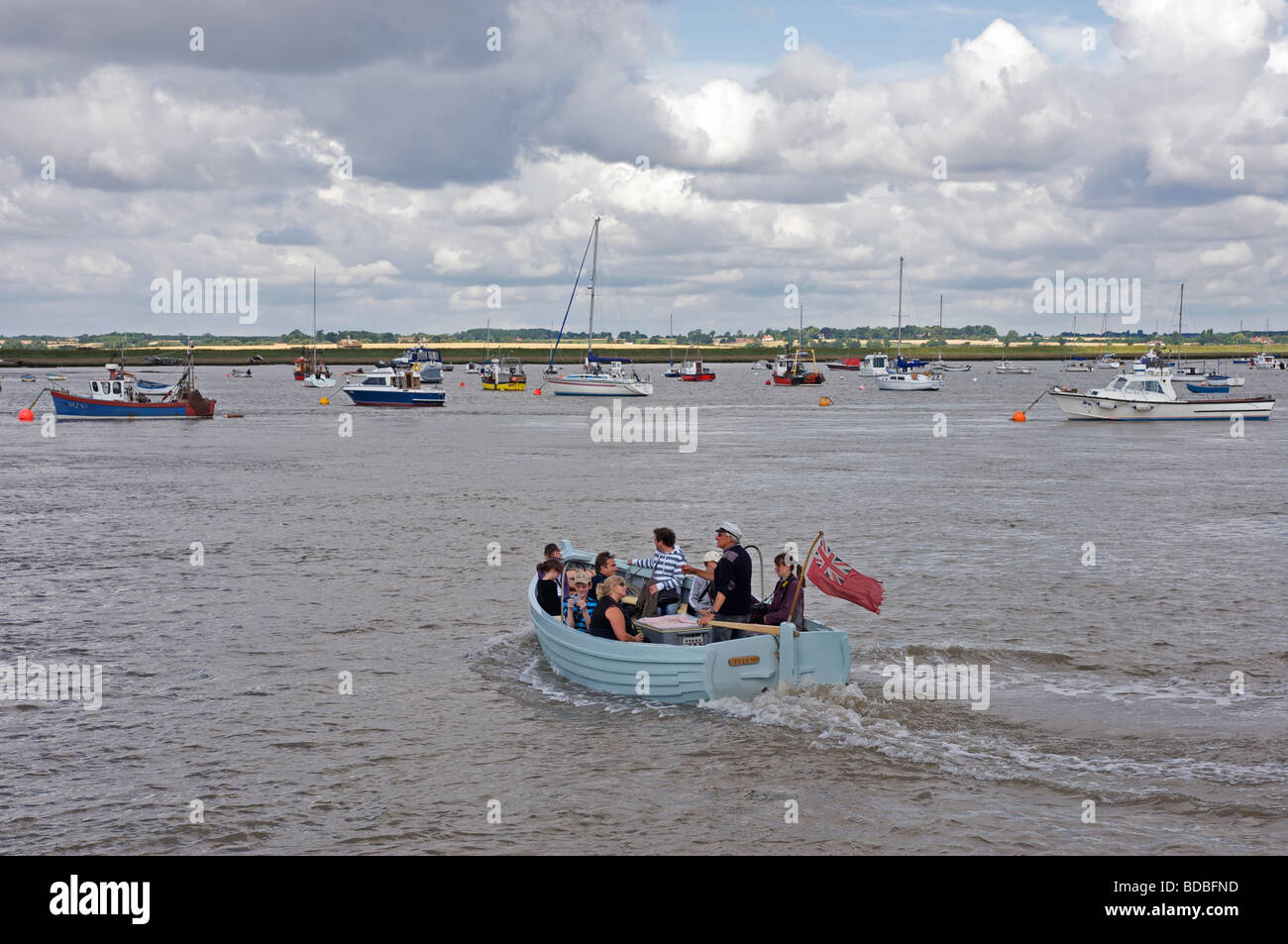 Felixstowe Ferry Harbour Master taking tourists on a trip on the river ...
