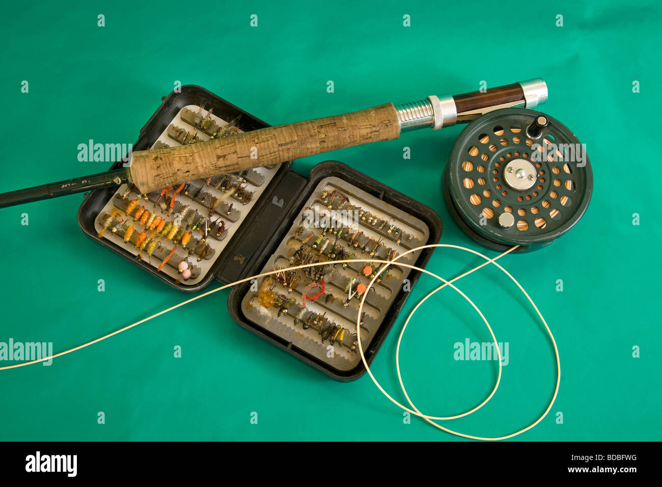 A fly rod, fly reel, trout fishing net, and box of artificial flies ...