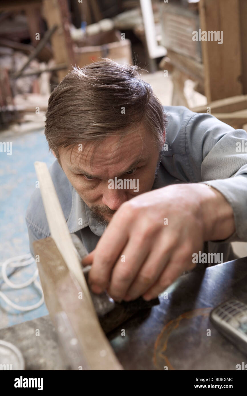 carpenter fixing piece of wood with hand-vice Stock Photo - Alamy