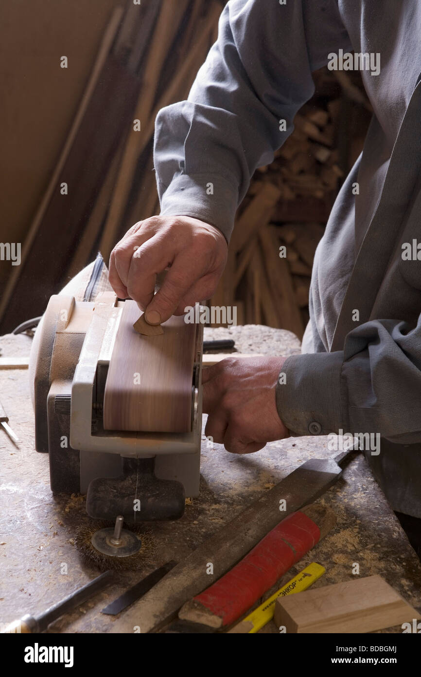 carpenter grinding piece of wood Stock Photo - Alamy