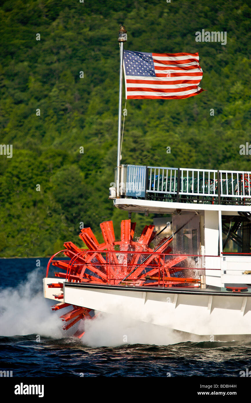 rear (from side) of river paddle boat with american flag waving in the ...