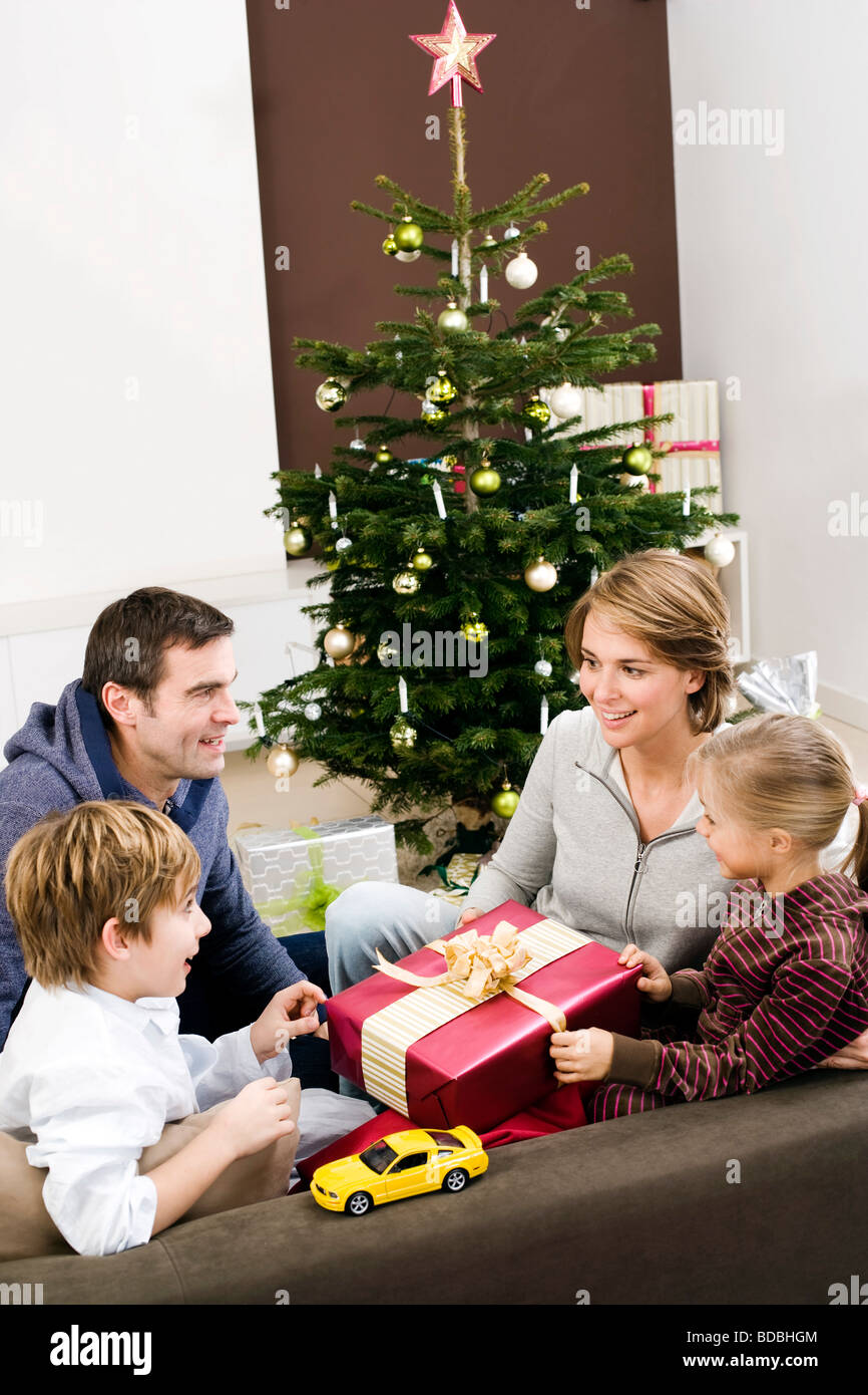 family exchanging presents on christmas morning Stock Photo - Alamy