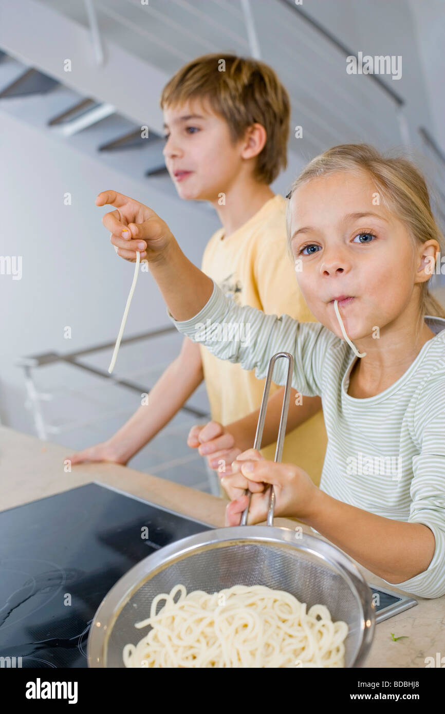 young girl tasting spaghetti Stock Photo - Alamy