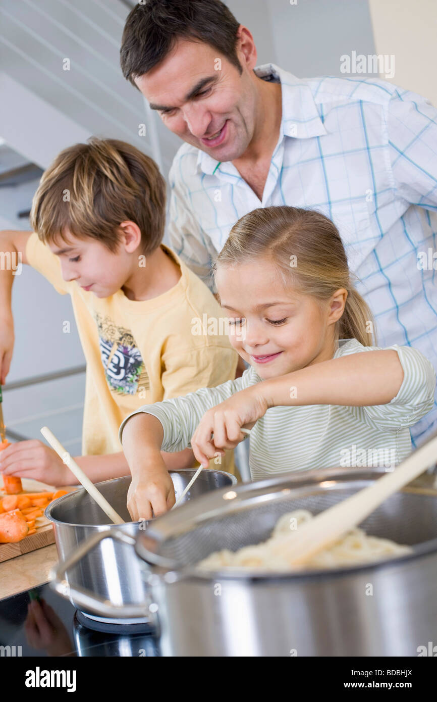 father watching his children cook Stock Photo - Alamy