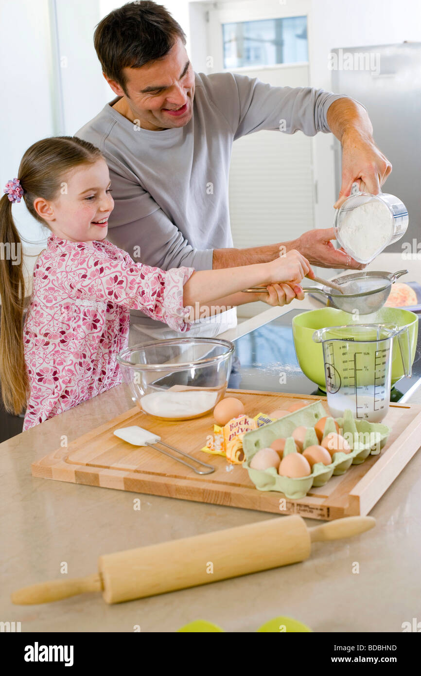 father and daughter making cake together Stock Photo - Alamy