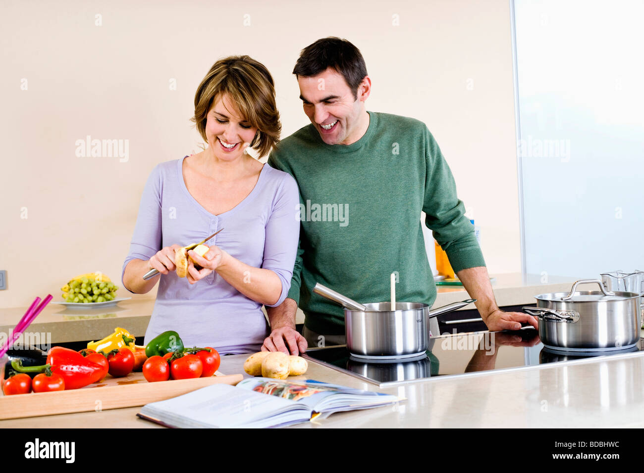 portrait of couple cooking in kitchen together Stock Photo - Alamy