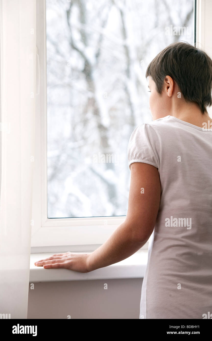 woman looking out of window Stock Photo - Alamy