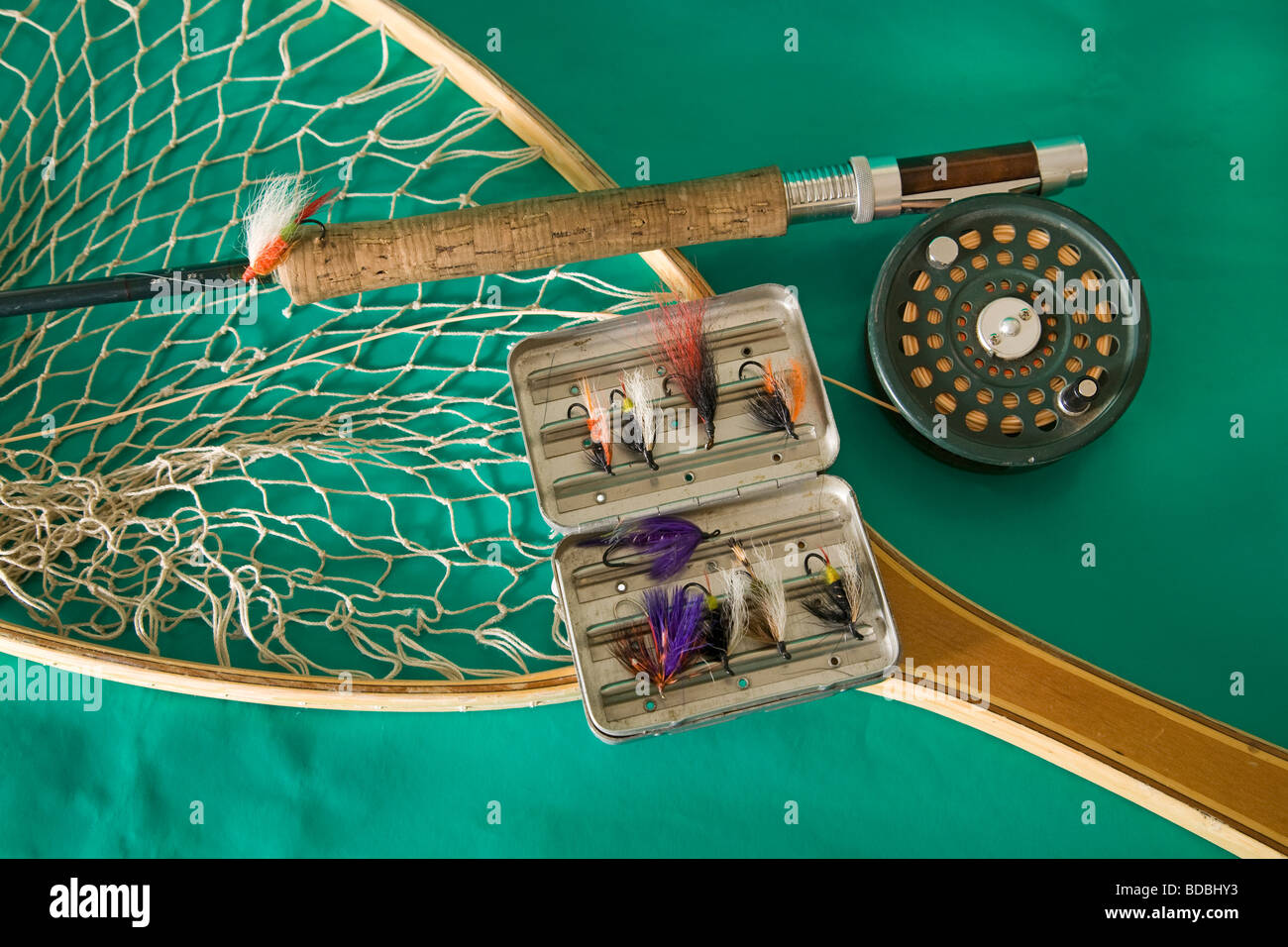 A fly rod, fly reel, trout fishing net, and box of artificial flies ...