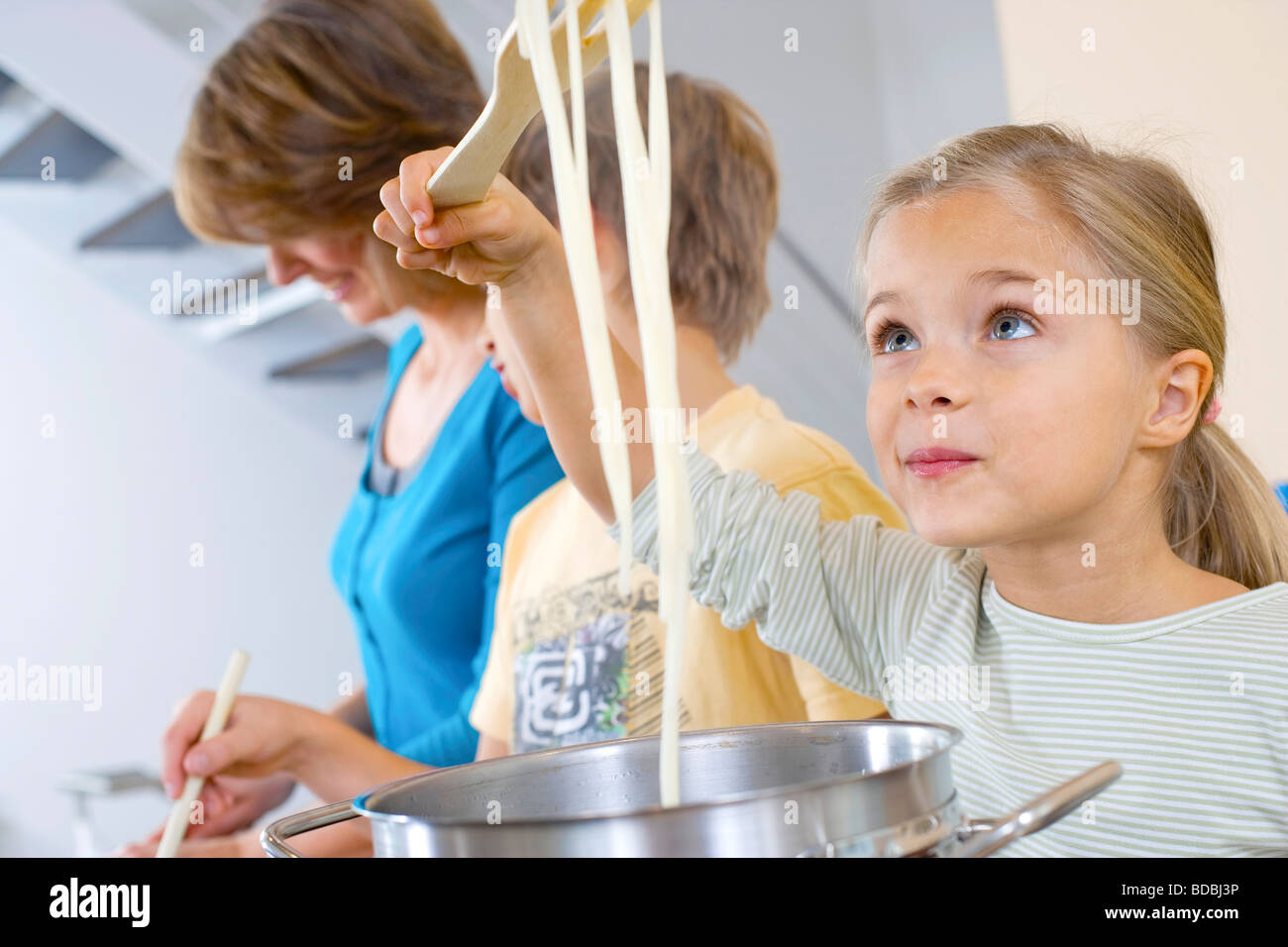 portrait of young girl cooking pasta Stock Photo - Alamy