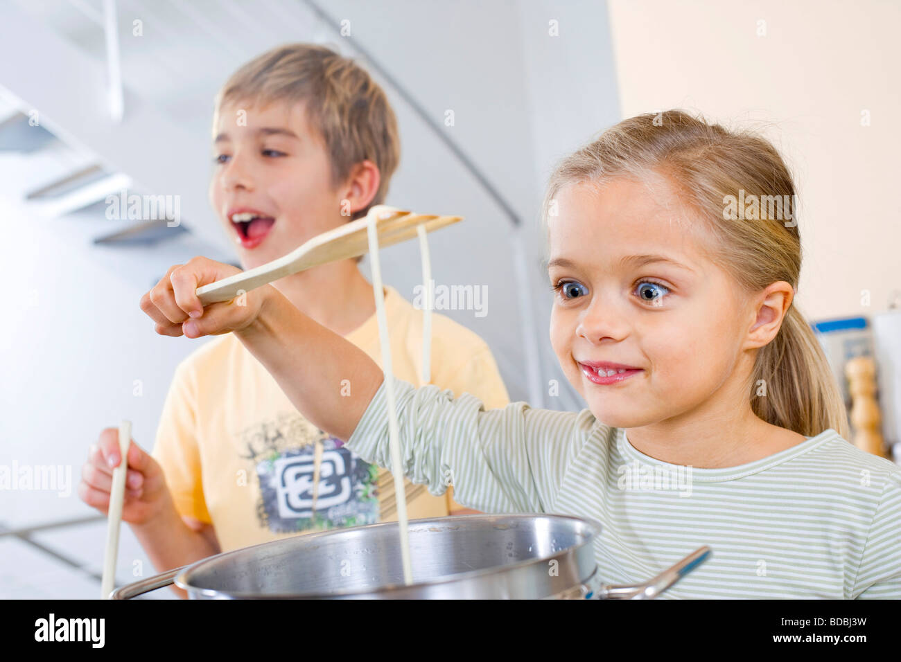 portrait of young girl cooking pasta Stock Photo - Alamy