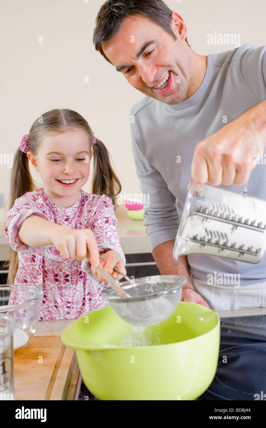 father and young daughter cooking together Stock Photo - Alamy