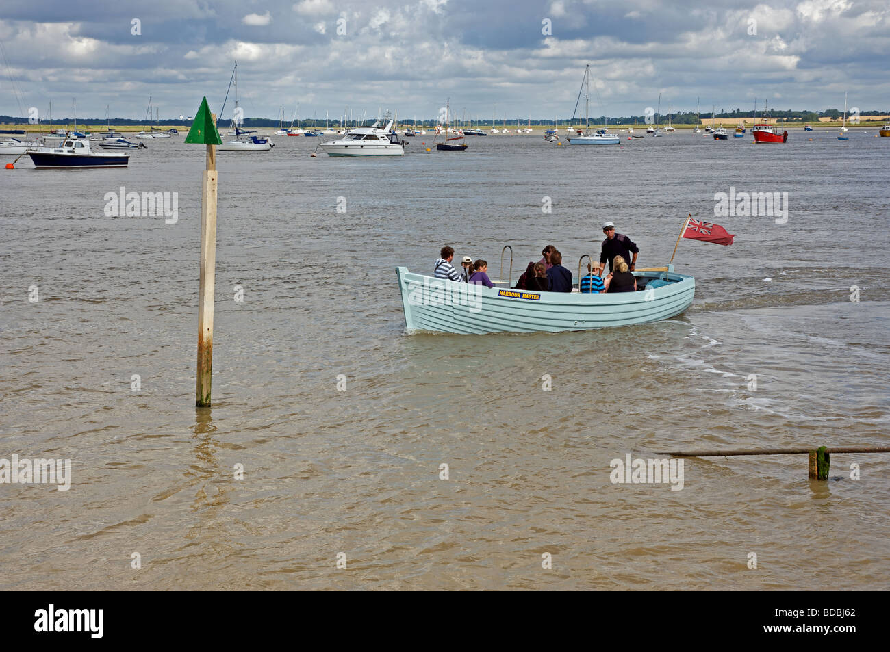 Felixstowe Ferry Harbour Master taking tourists on a trip on the river ...