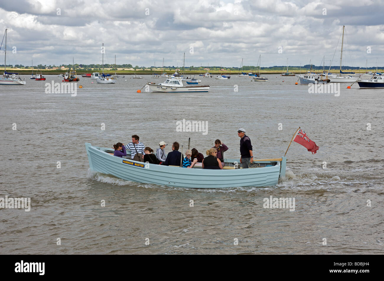 Felixstowe Ferry Harbour Master taking tourists on a trip on the river ...