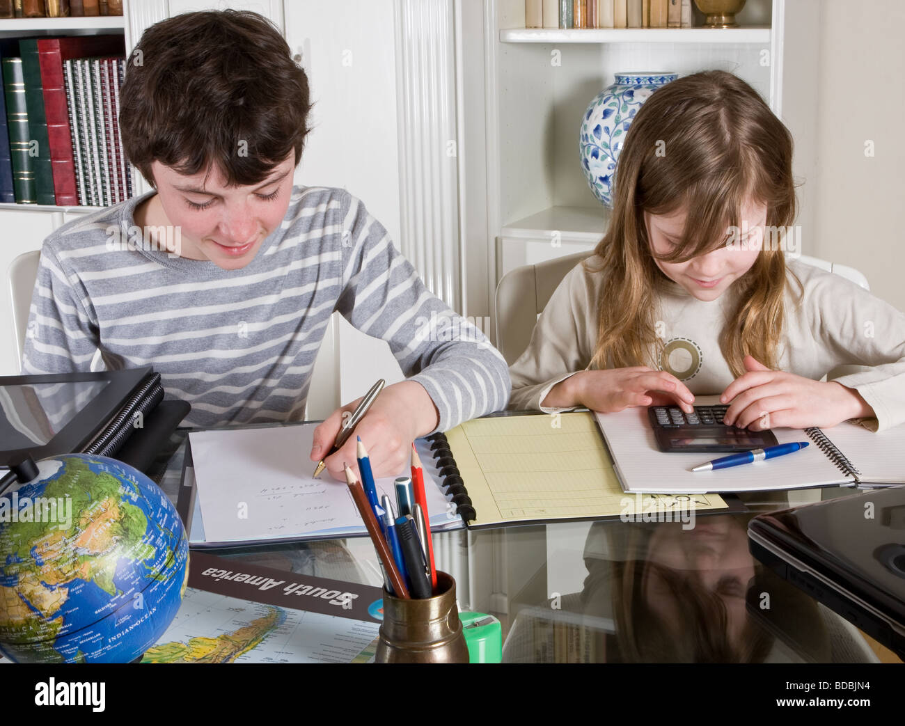 Two teenagers doing their homework at home Stock Photo - Alamy