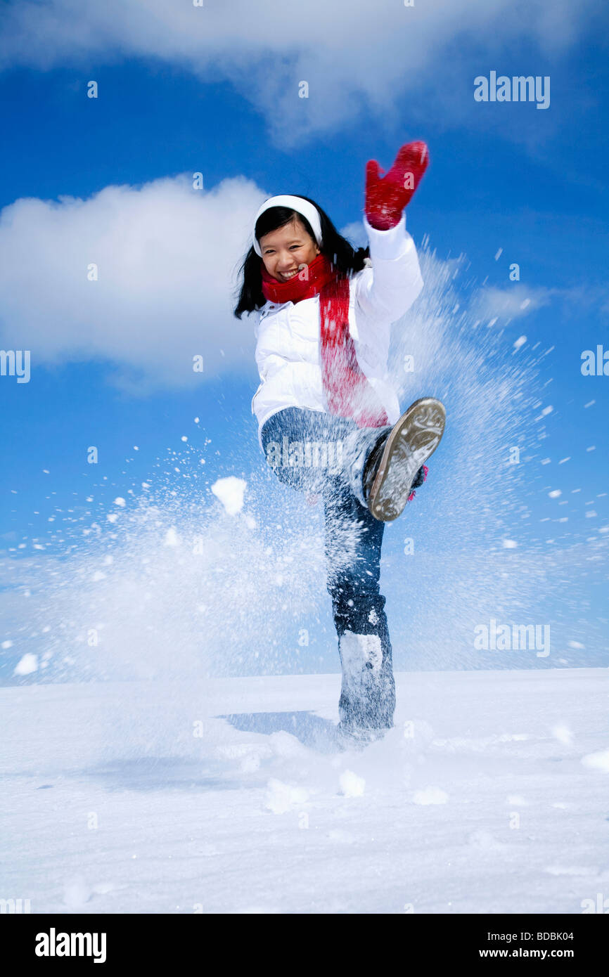 portrait of asian woman kicking snow in winter Stock Photo - Alamy