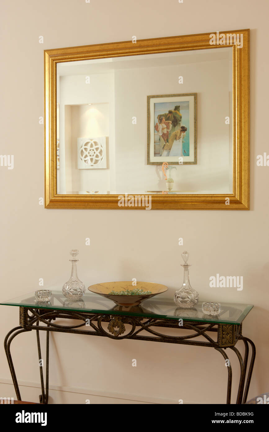 Rectangular gilt mirror above metal console table Stock Photo - Alamy