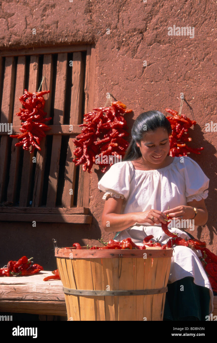 Native American woman tying red chili ristras, New Mexico Stock Photo ...