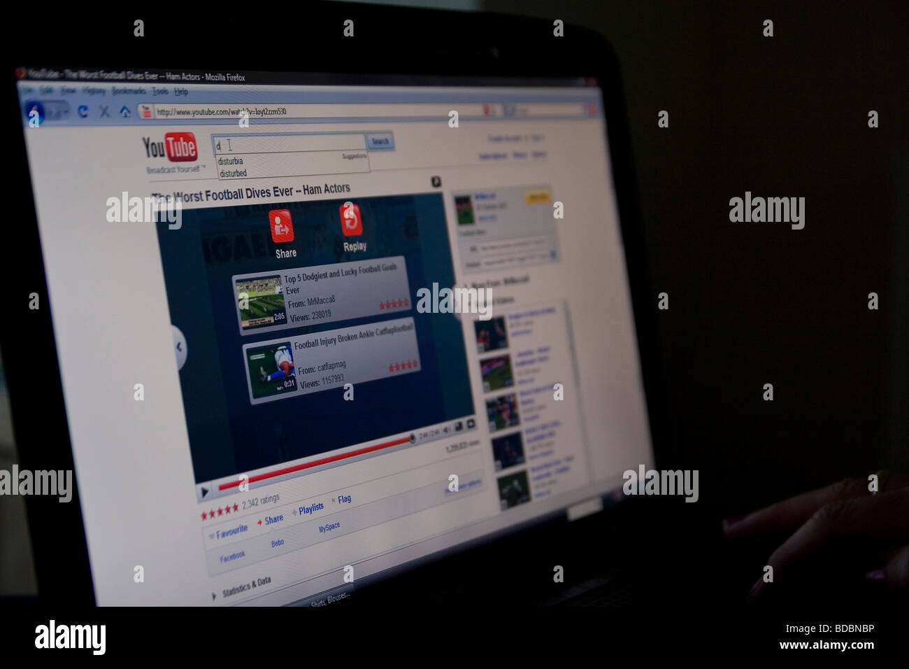 A user browsing YouTube in the dark Stock Photo - Alamy
