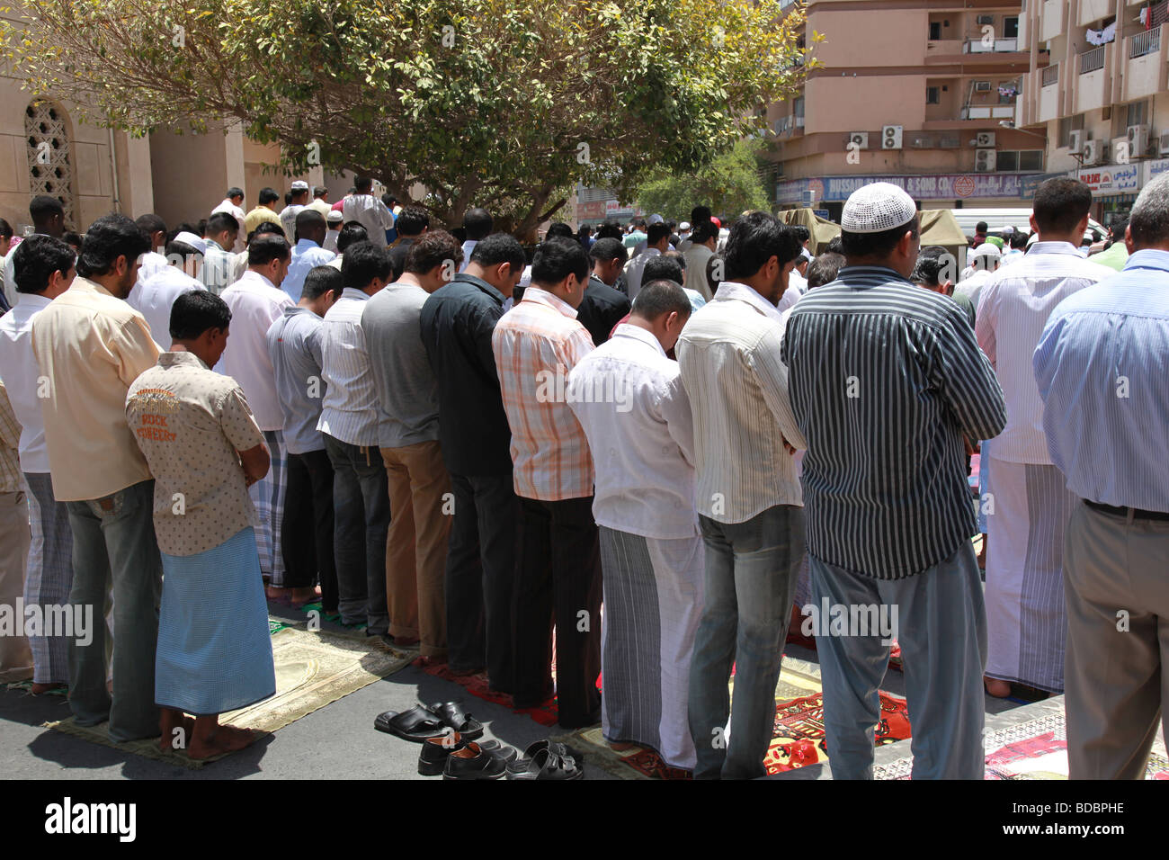 Call for prayer in Dubai. Hundreds of men praying in the streets ...