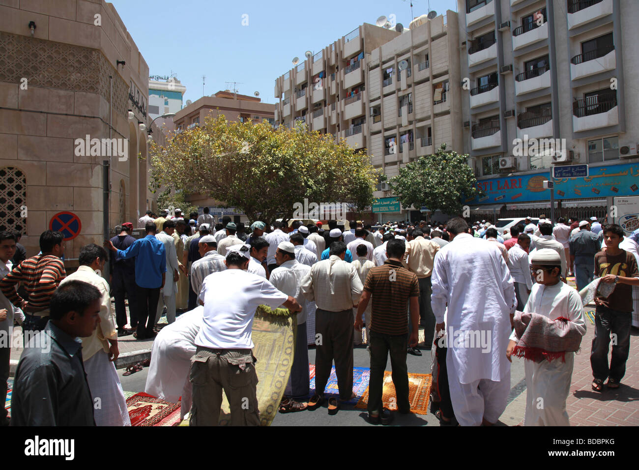 Call for prayer in Dubai. Hundreds of men praying in the streets ...