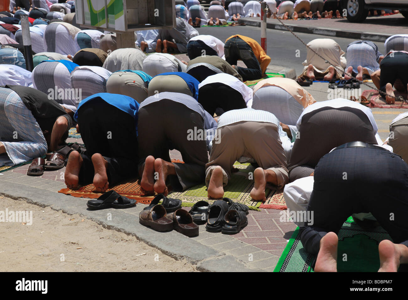Call for prayer in Dubai. Hundreds of men praying in the streets ...