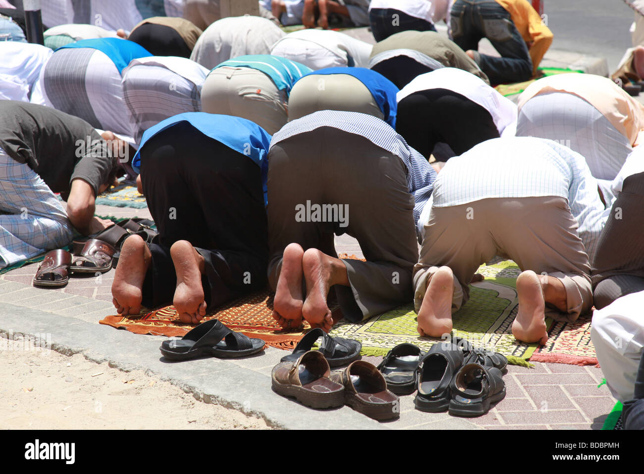 Call for prayer in Dubai. Hundreds of men praying in the streets ...